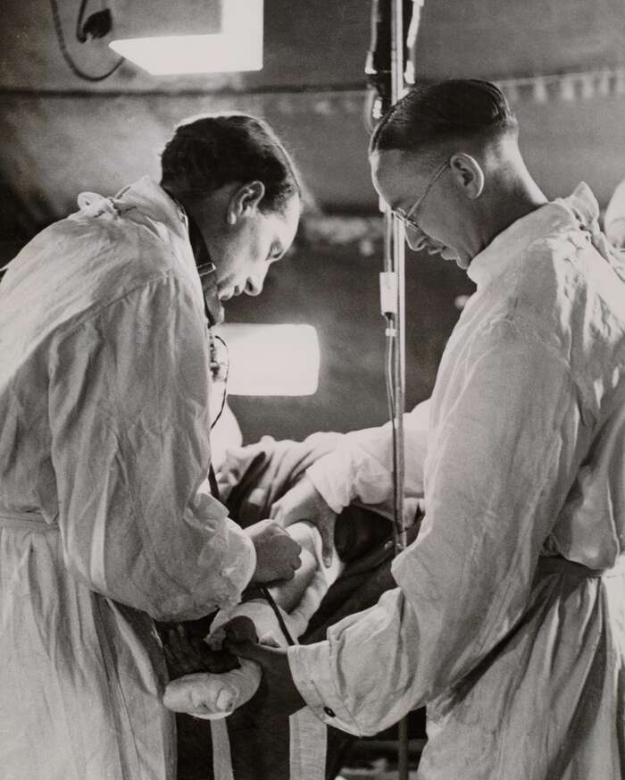 Wounded soldier receiving blood transfusion at a casualty clearing ...