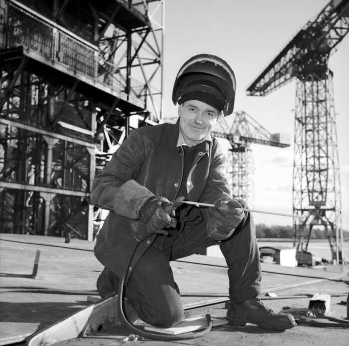 Welder smiles for the camera, Clydebank, 1965 | ScotlandsPeople