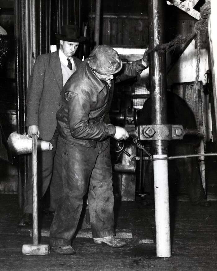 Men removing drilled core on boring tower in the Forth, 1955 ...